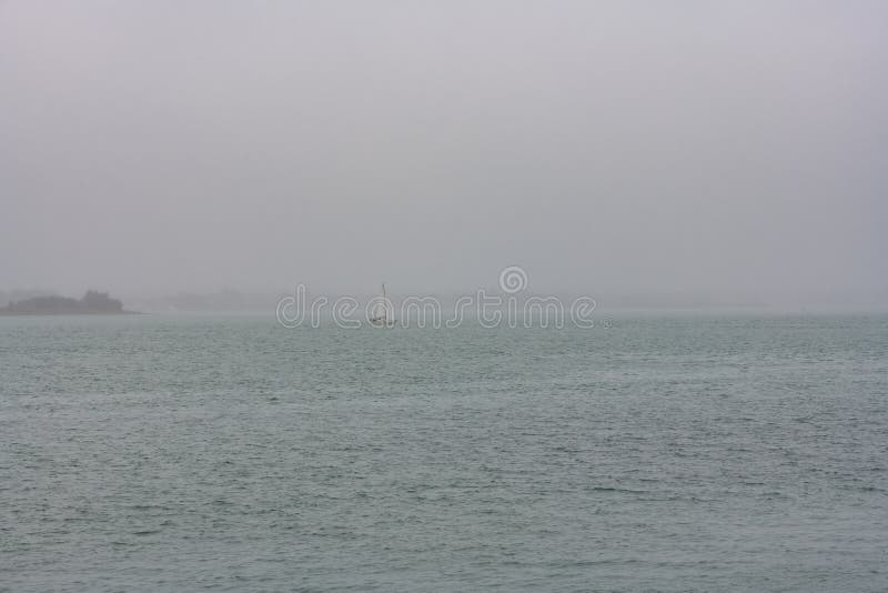 A sailboat in the mist stock photo. Image of morbihan - 239324924