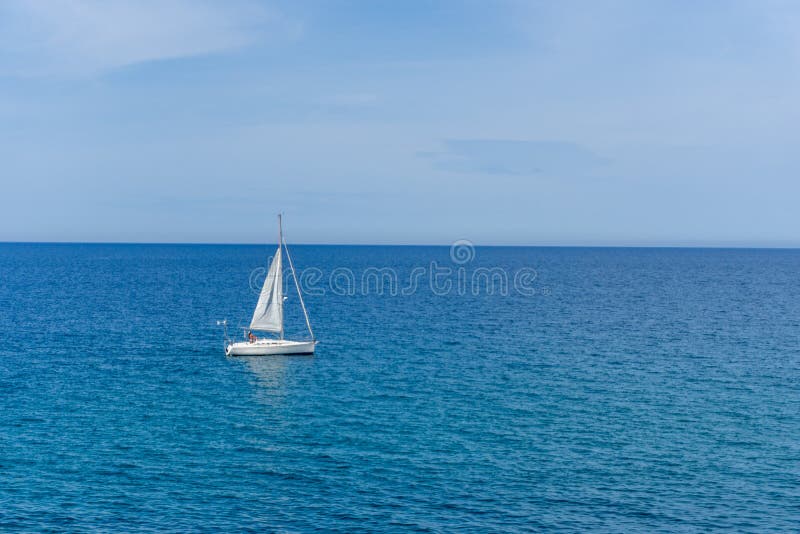 Sailboat Out at Sea on Blue Water Stock Image - Image of boat, water ...
