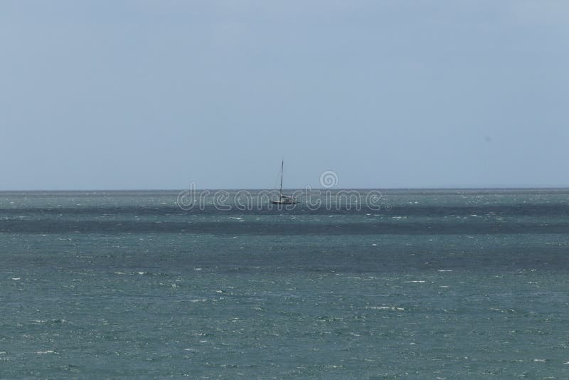 Sailboat Riding the Choppy Waves Off the Cornish Coast Stock Image ...