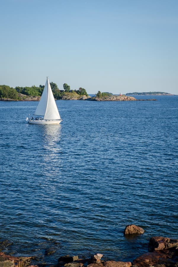 Sailboat and Rocky Coastline in Nice Clean Sea Stock Image - Image of ...