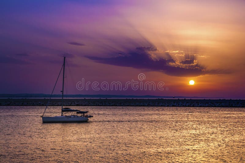 Sailing boat at sunset stock photo. Image of voyage, away - 74751956