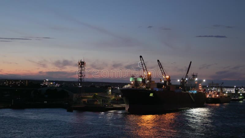 Sailing by Cargo Ship with Loading Cranes on Deck and Sunset Color in ...