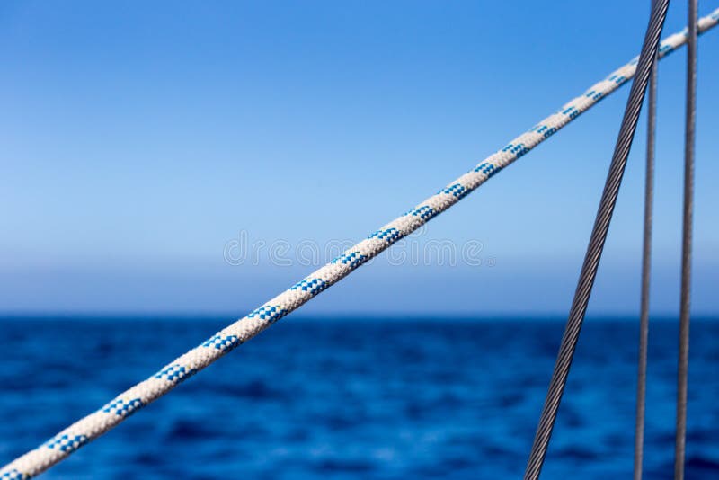 Sailing Ropes in Front of Bight Blue Ocean and Sky Background Stock ...