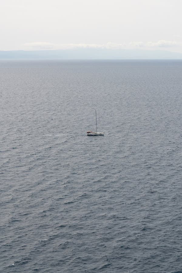 A Graceful Sailing Yacht Glides Across the Open Sea, Its Sails Catching ...