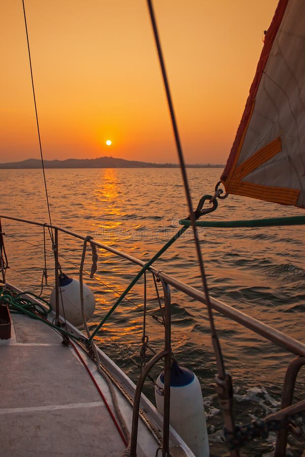 Yacht Sailing Towards the Sunset Stock Photo - Image of horizon, island ...