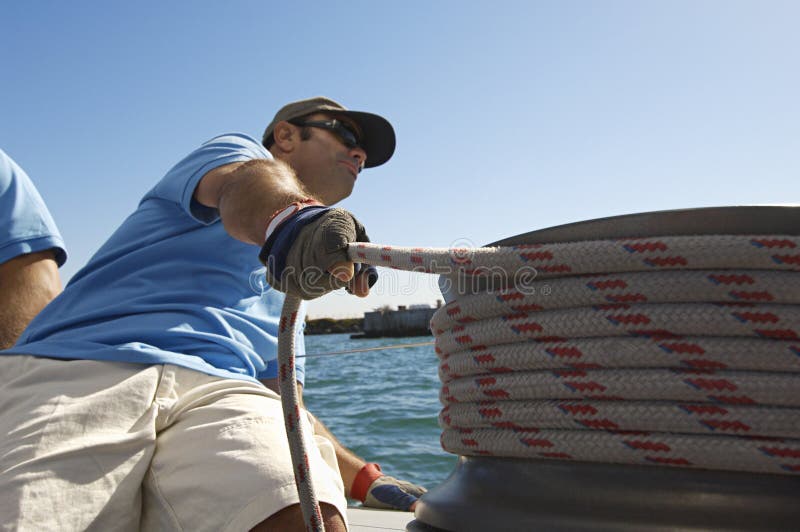 Sailor Adjusting Rope on Boat Stock Photo - Image of sailor, boating ...