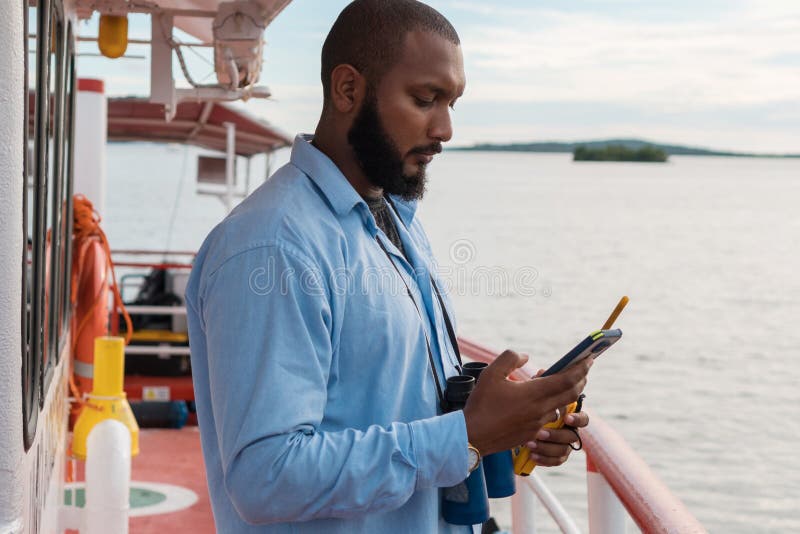 Sailor on Deck Checking His Phone. Boat with a Crew Member Using His ...
