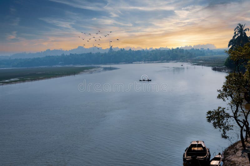 Sailor Navigating a Vessel on a Stunning River, with Birds Soaring in ... Sailor Navigating a Vessel on a Stunning River, with Birds Soaring in ...