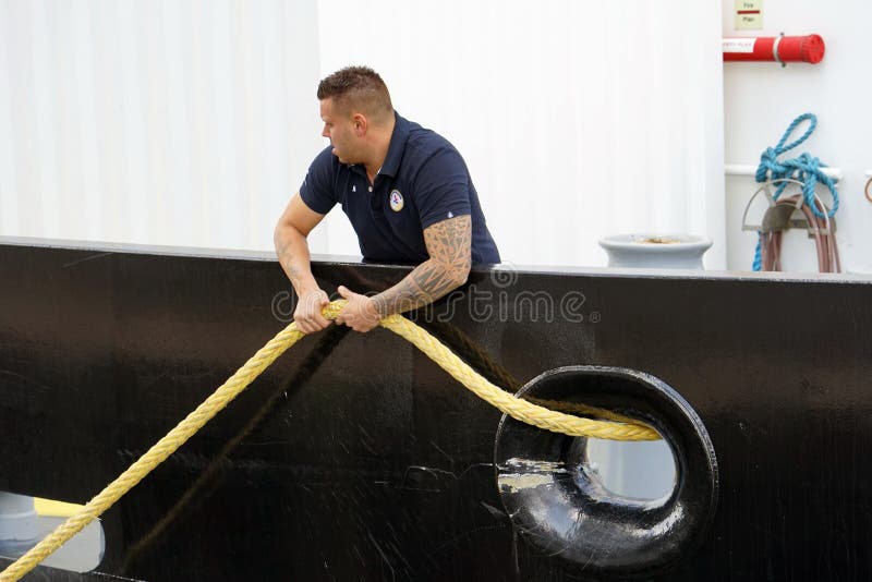 Sailor on the Ship Pulling Mooring Cable. Editorial Photo - Image of ...