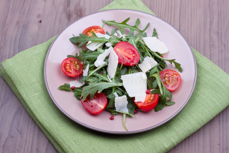 Salad with Ruccola and Tomatoes Stock Photo - Image of wooden, plate ...
