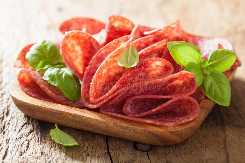 Salami Slices in Wooden Plate Stock Photo - Image of slice, dinner ...