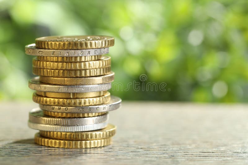 Salary Concept. Stacked Coins on Grey Table Against Blurred Background ...