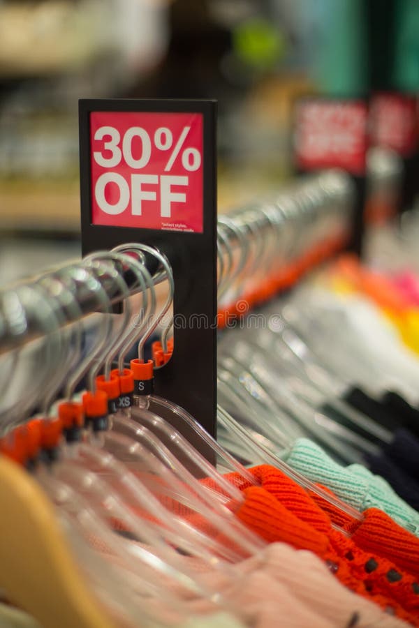 Sale Clearance Sign on Rail in Clothes Shop Stock Image - Image of sign ...