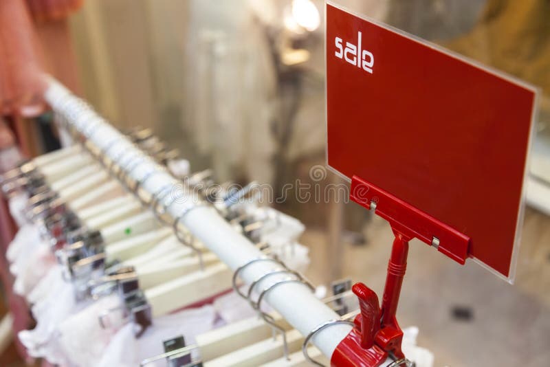 Sale Clearance Sign on Rail in Clothes Shop Stock Image - Image of sign ...