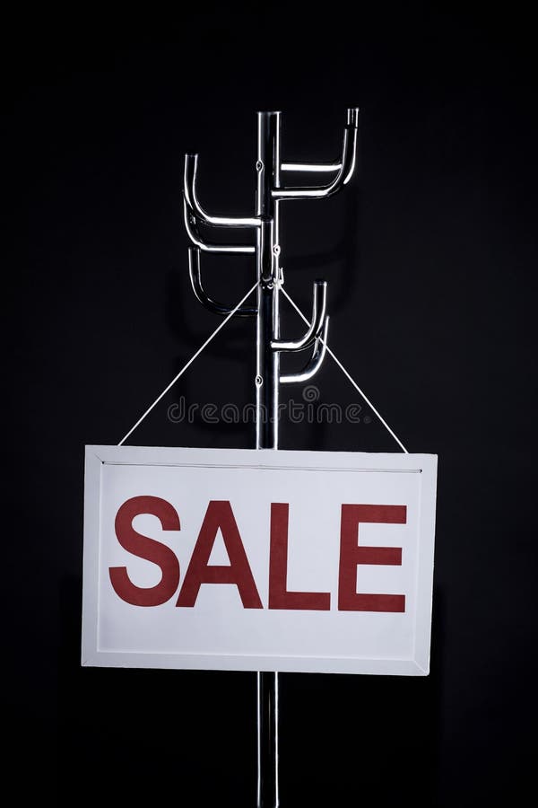 Sale Signboard Hanging on Coat Rack on Black Stock Photo - Image of ...