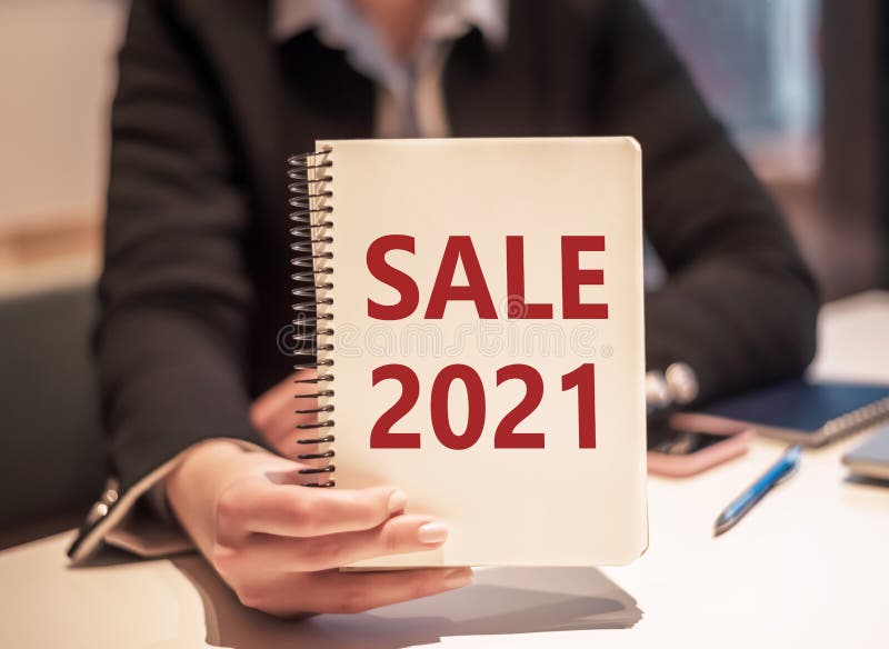 SALE 2021 Text on Notebook Shown by Business Woman Stock Photo - Image ...