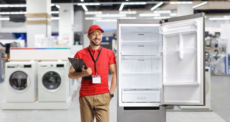 Sales Assistant Leaning on a Fridge Stock Image - Image of smiling ...