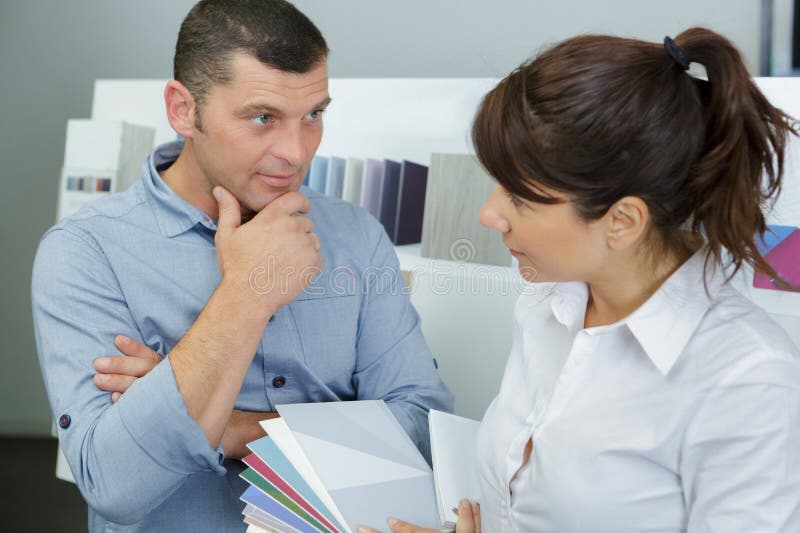 Sales Assistant Looking through Colour Options with Client Stock Image ...