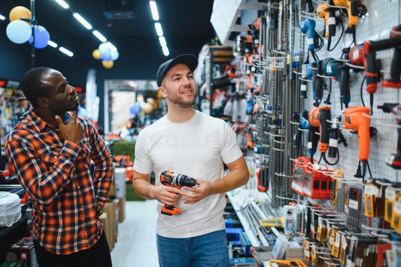 A Sales Consultant Helps a Client Choose a Screwdriver in a Hardware ...