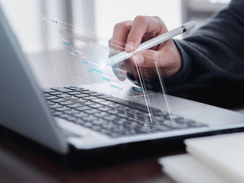 Sales Manager Uses a Laptop To Update Progress Plan with Gantt Chart ... Sales Manager Uses a Laptop To Update Progress Plan with Gantt Chart ...