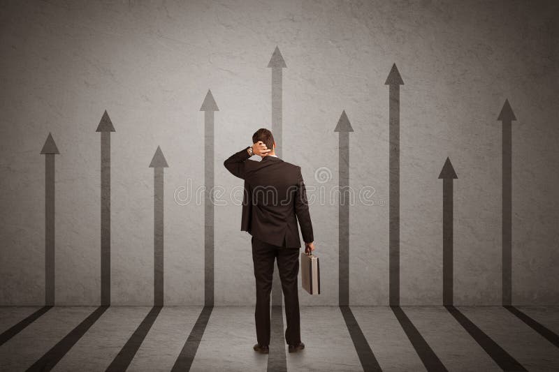 Sales Person Looking at Arrows Pointing Up on the Wall Concept Stock ...
