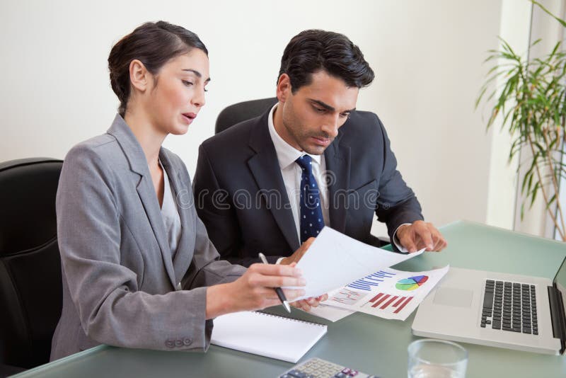 Sales Persons Working with a Notebook Stock Photo - Image of business ...