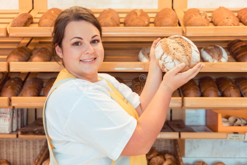 Saleslady in Bakery Shop Presenting Bread Stock Image - Image of fresh ...