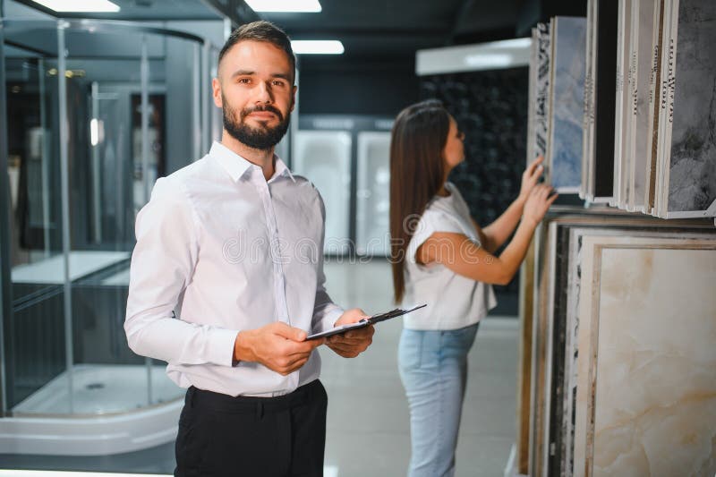 A Salesman Advises a Female Customer on the Choice of Interior Doors in ...