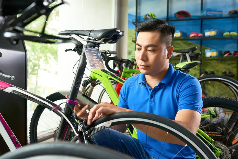 Salesman assembling bike stock image. Image of sport - 136795505
