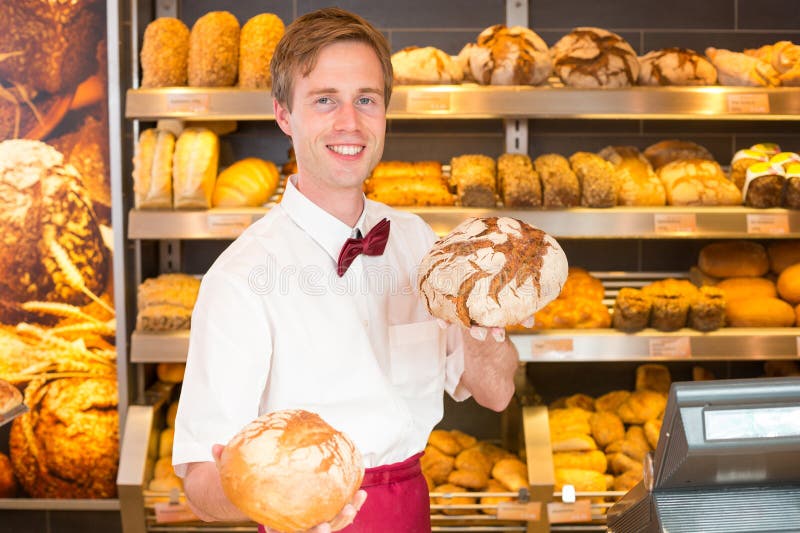 Salesman in Bakery Holding Different Types of Bread Stock Image - Image ...