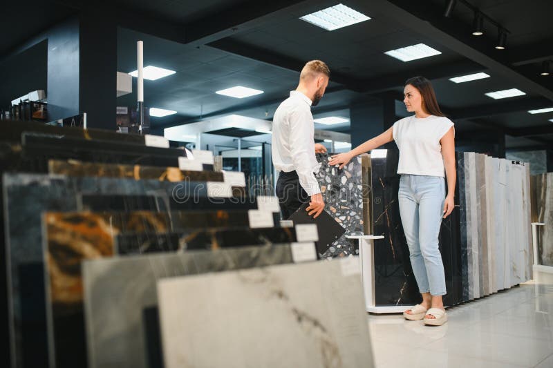 Salesman and a Female Customer Choosing a Right Ceramic Tile for Her ...