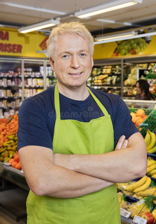 Salesman with Hands Folded Standing in Grocery Store Stock Photo ...