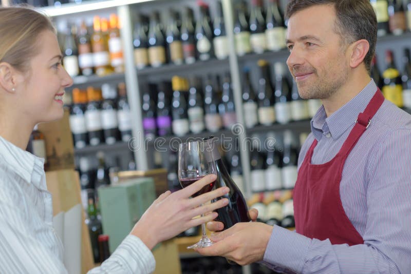 Salesman Passing Glass Wine To Customer Stock Photo - Image of friendly ...