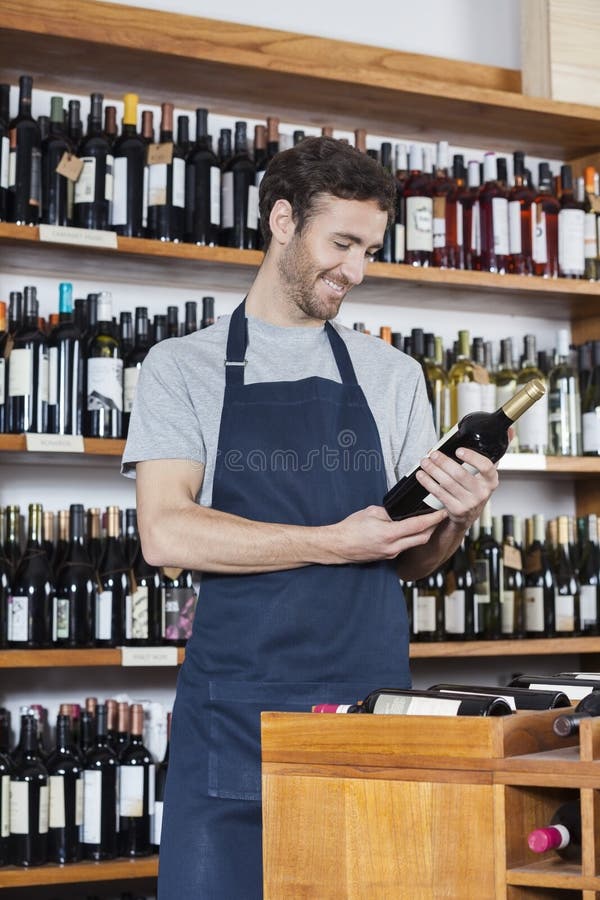 Salesman Reading Label of Wine Bottle in Store Stock Image - Image of ...