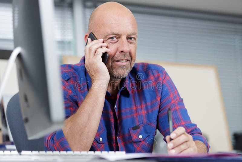 Salesman Sat at Computer Desk Talking on Smartphone Stock Photo - Image ...