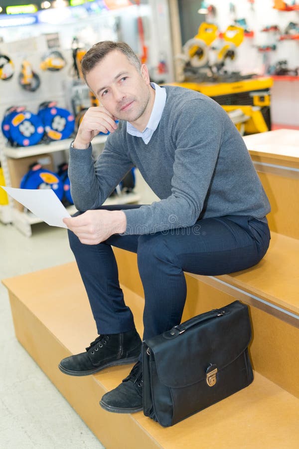 Salesman Sat on Steps in Hardware Store Stock Photo - Image of ...