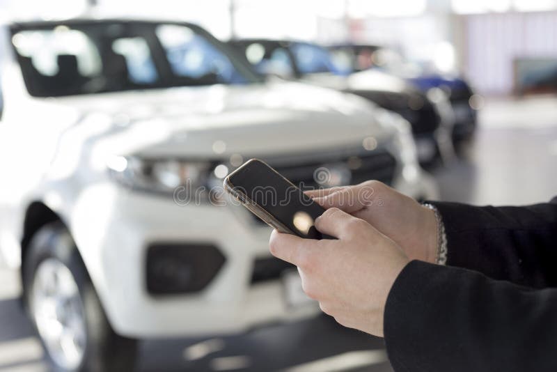 Salesman Using Mobile Smart Phone at Dealer Showroom. Modern Working ...