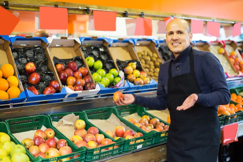 Salesman Working in Delicatessen Section of Ordinary Grocery Stock ...