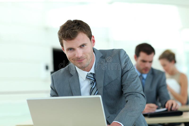 Salesman Working on Laptop at Office Stock Photo - Image of foreground ...