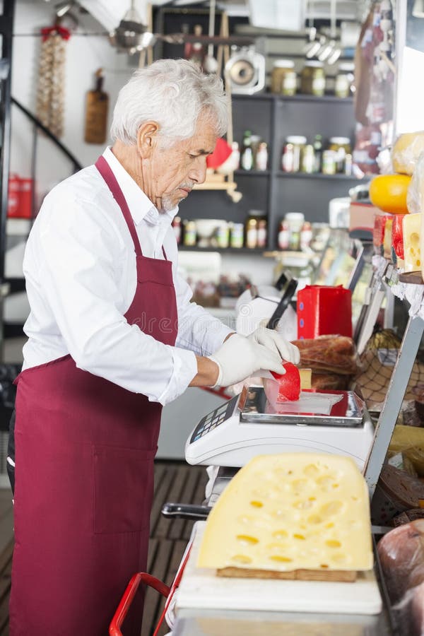 Salesman Wrapping Cheese at Counter in Shop Stock Image - Image of ...