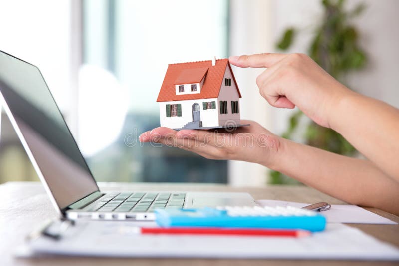 The Salesperson Introduces the House in Front of the Computer Stock ...