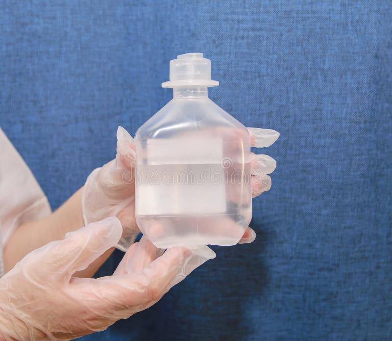 Hands in Clear Gloves Hold Saline Solution and Draw into Syringe Stock ...