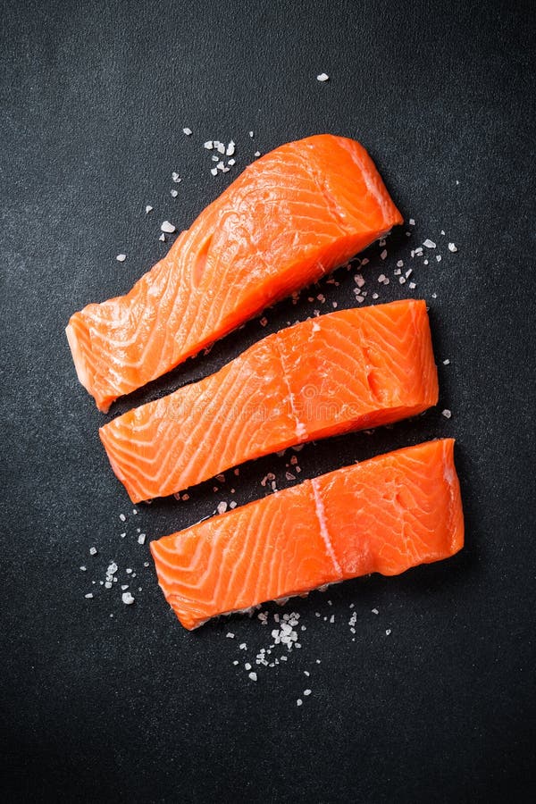 Salmon Fillet, Raw Fresh Fish at Black Table. Stock Photo - Image of ...