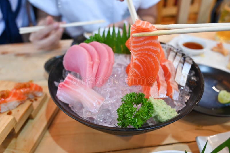 Salmon Sashimi Slice on Chopsticks Stock Image - Image of japanese ...