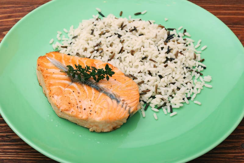 Salmon with wild rice stock photo. Image of lemon, vertical - 7774742