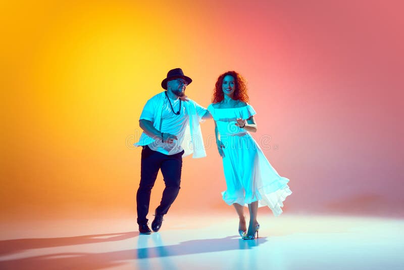 Salsa Dancers Practice with Passion in Neon Light Against Gradient ...