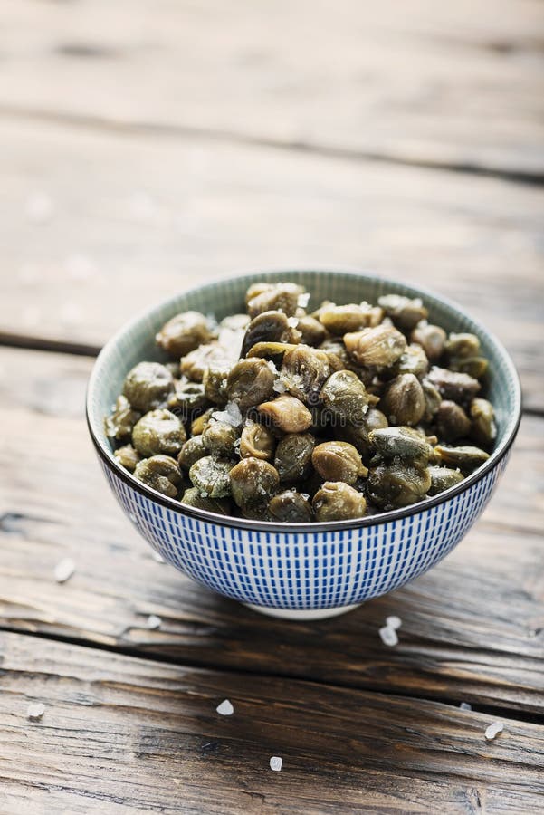 Salt Capers on the Wooden Table Stock Photo - Image of bowl, food ...
