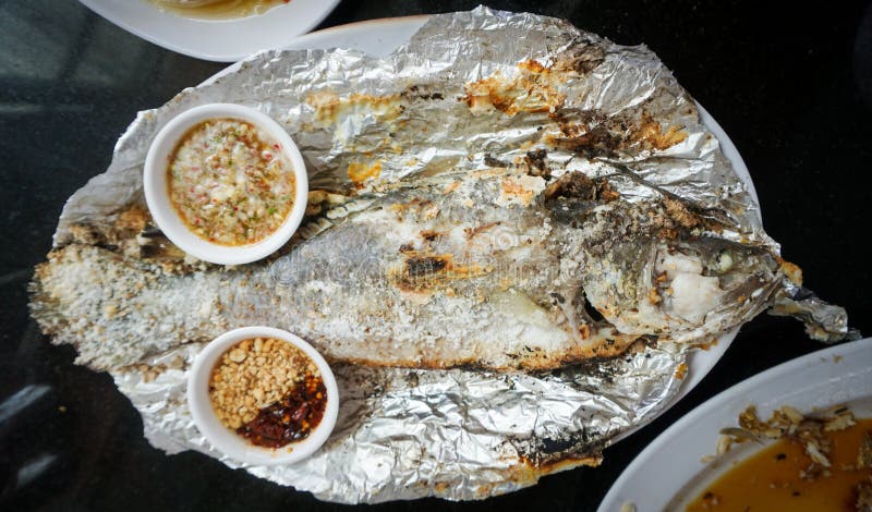 Salt-Crusted Grilled Fish Eaten with Seafood Sauce. Stock Image - Image ...