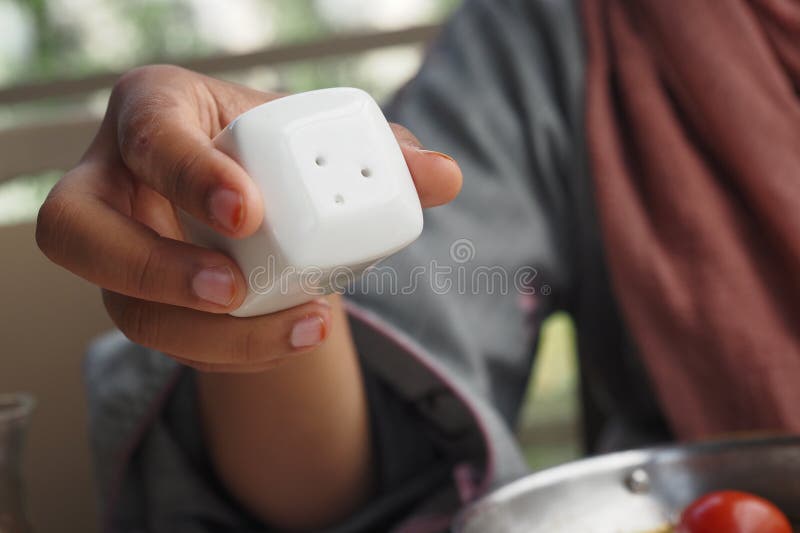 Salt Falls from a Salt Shaker Stock Photo - Image of motion, finger ...