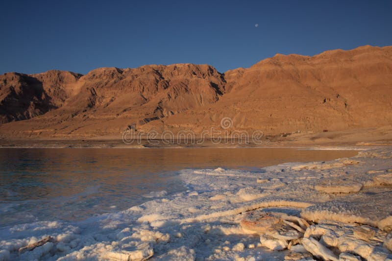 Salt Formations on Shore with Mountainous Backdrop Stock Photo - Image ...